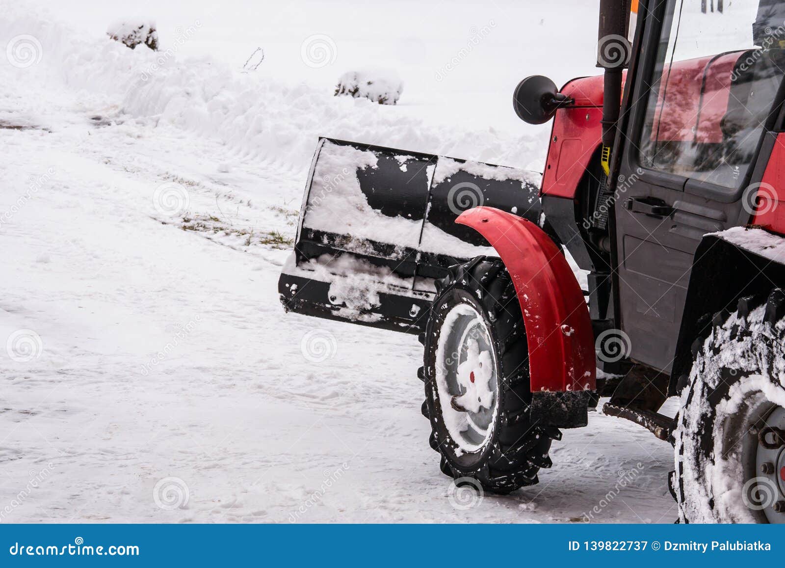 Snow Removal in the Winter the Tractor. Cleaning the Streets of Snow ...