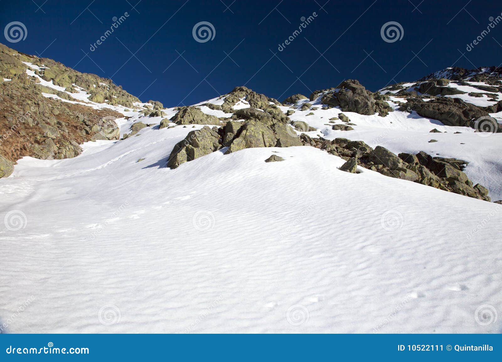 Snow slope with big rocks stock image. Image of snow - 10522111