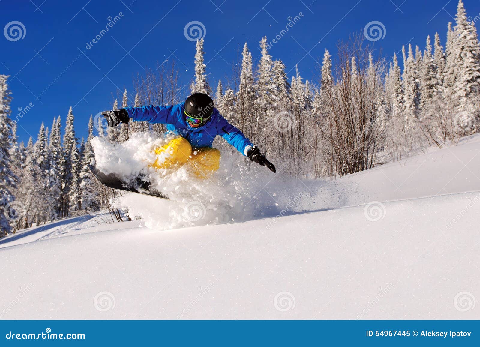 Snowboarder Doing a Toe Side Carve with Deep Blue Sky in Background ...
