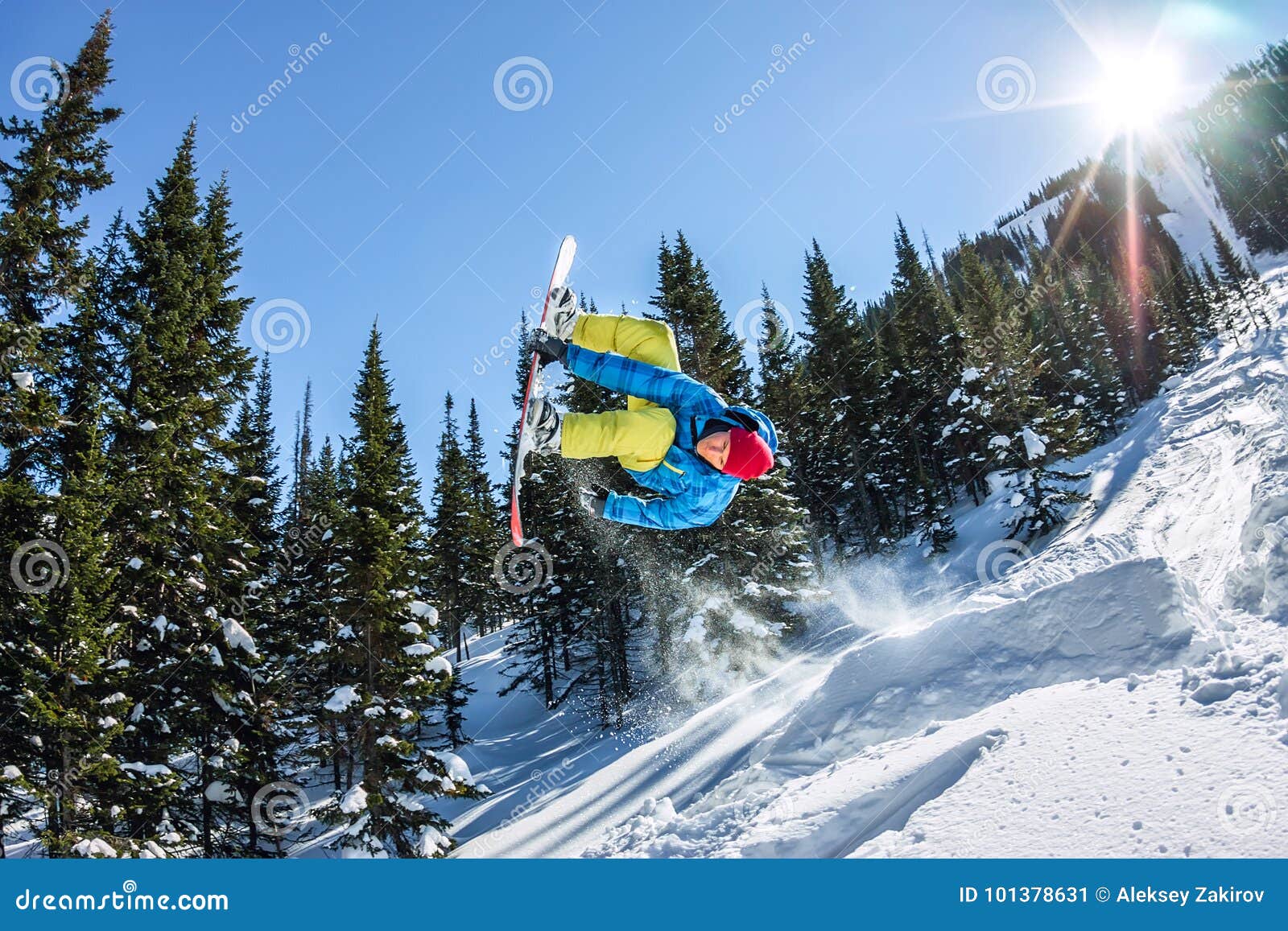 Snowboarder Freerider Jumping from a Snow Ramp in the Sun on a ...