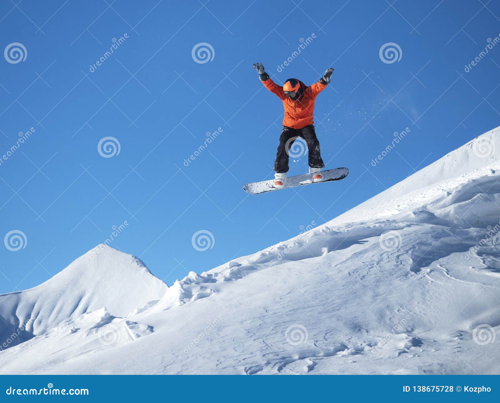 Snowboarder Jump in the Mountains Against the Blue Sky Stock Photo ...
