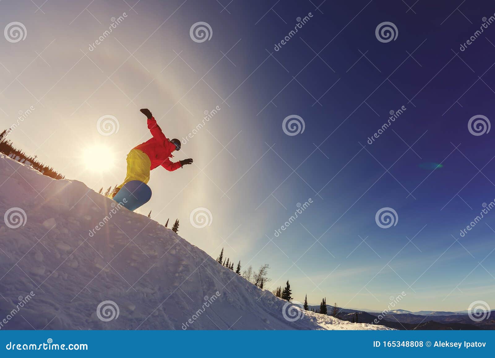 Snowboarder Jumping through Air with Deep Blue Sky in Background Stock ...