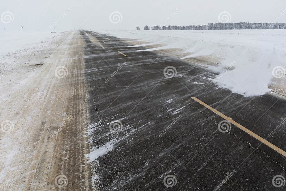 Snowfall and Blizzard Sweep the Road Stock Photo - Image of track ...