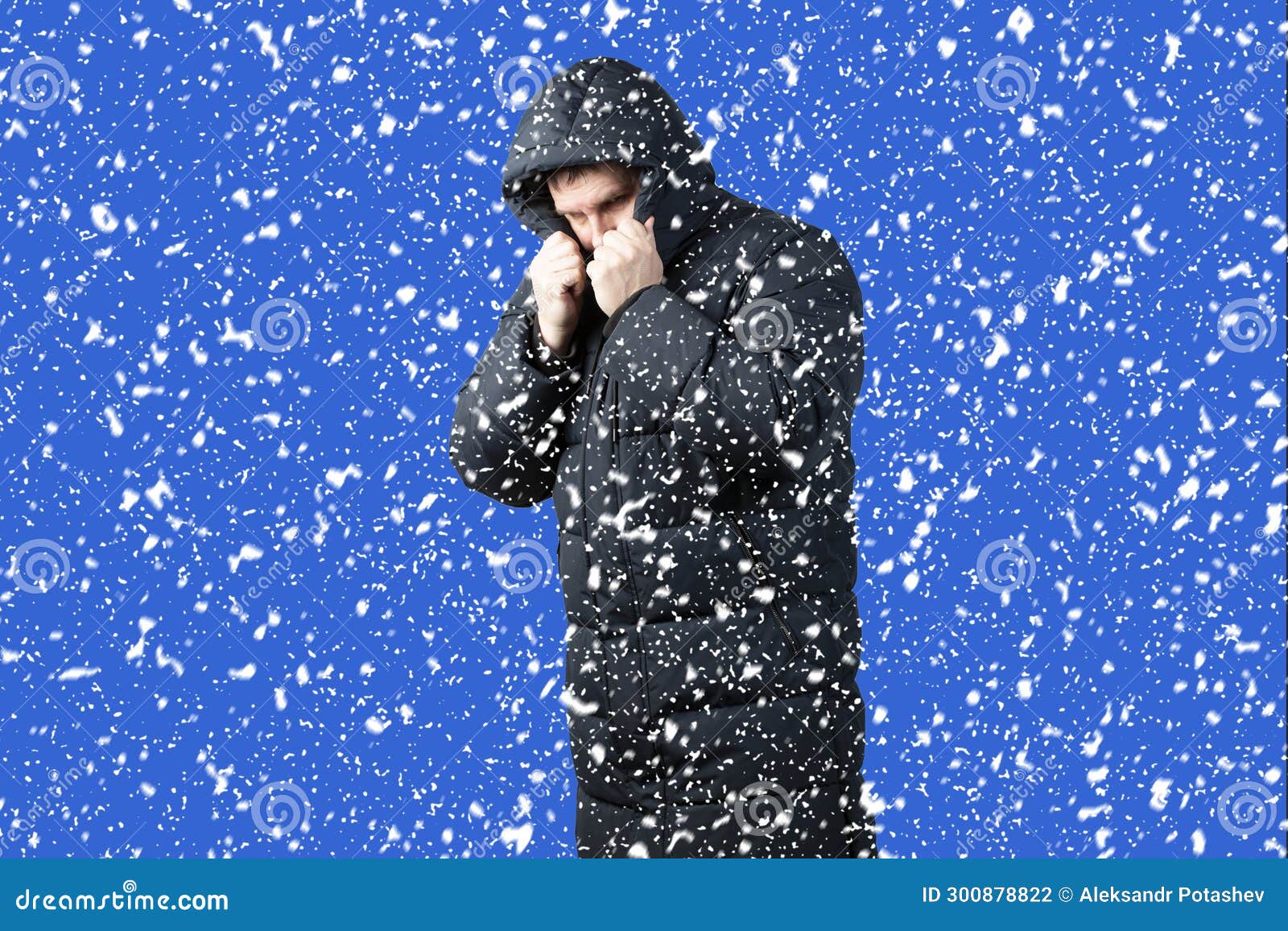 Snowfall and a Man in a Down Jacket.Cold Winter Weather Stock Photo ...