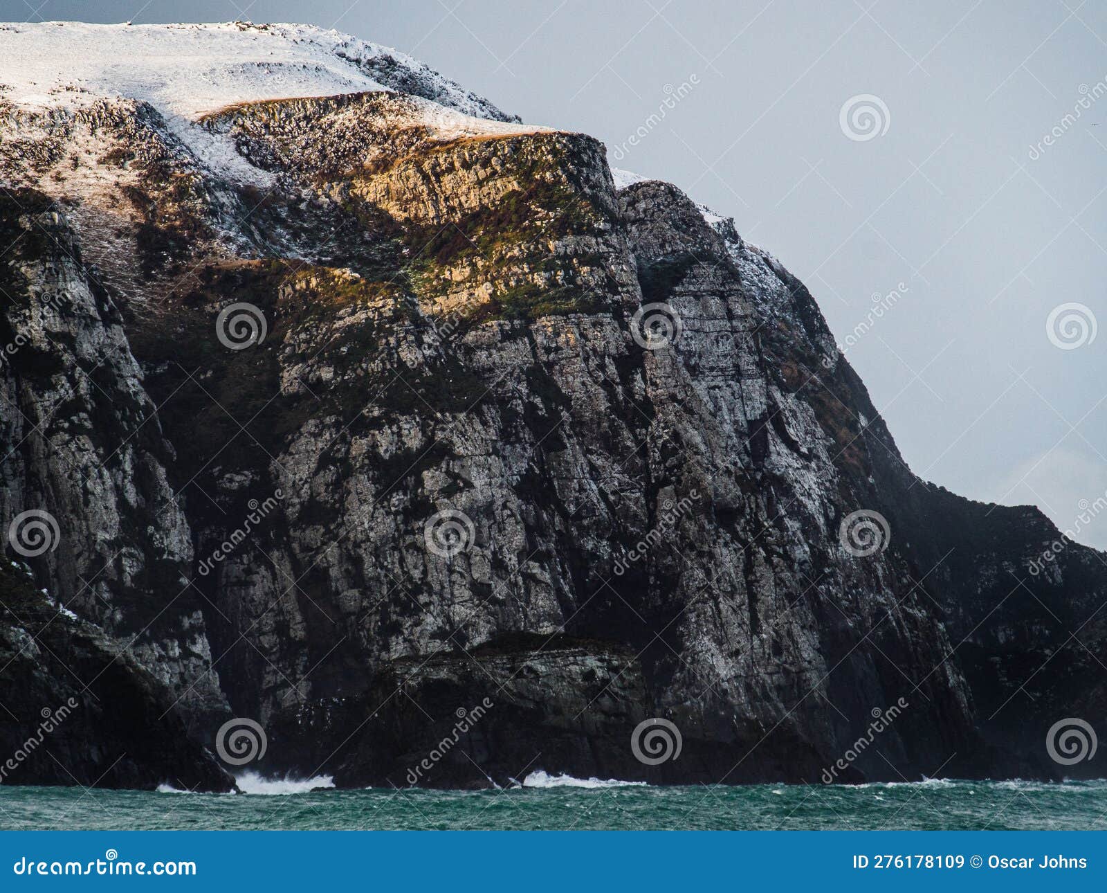 Snowy Mountain Cliffs Over Ocean Stock Image - Image of rock, snowy ...