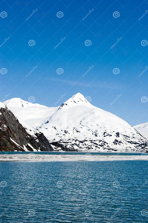 Snowy mountains by ocean stock photo. Image of touristic - 4327628