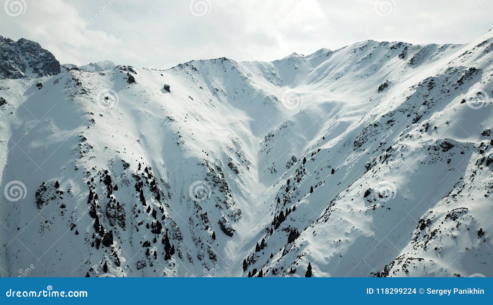 Snowy Mountains with White Sky. the View Over the Gorge and Snow Opens ...