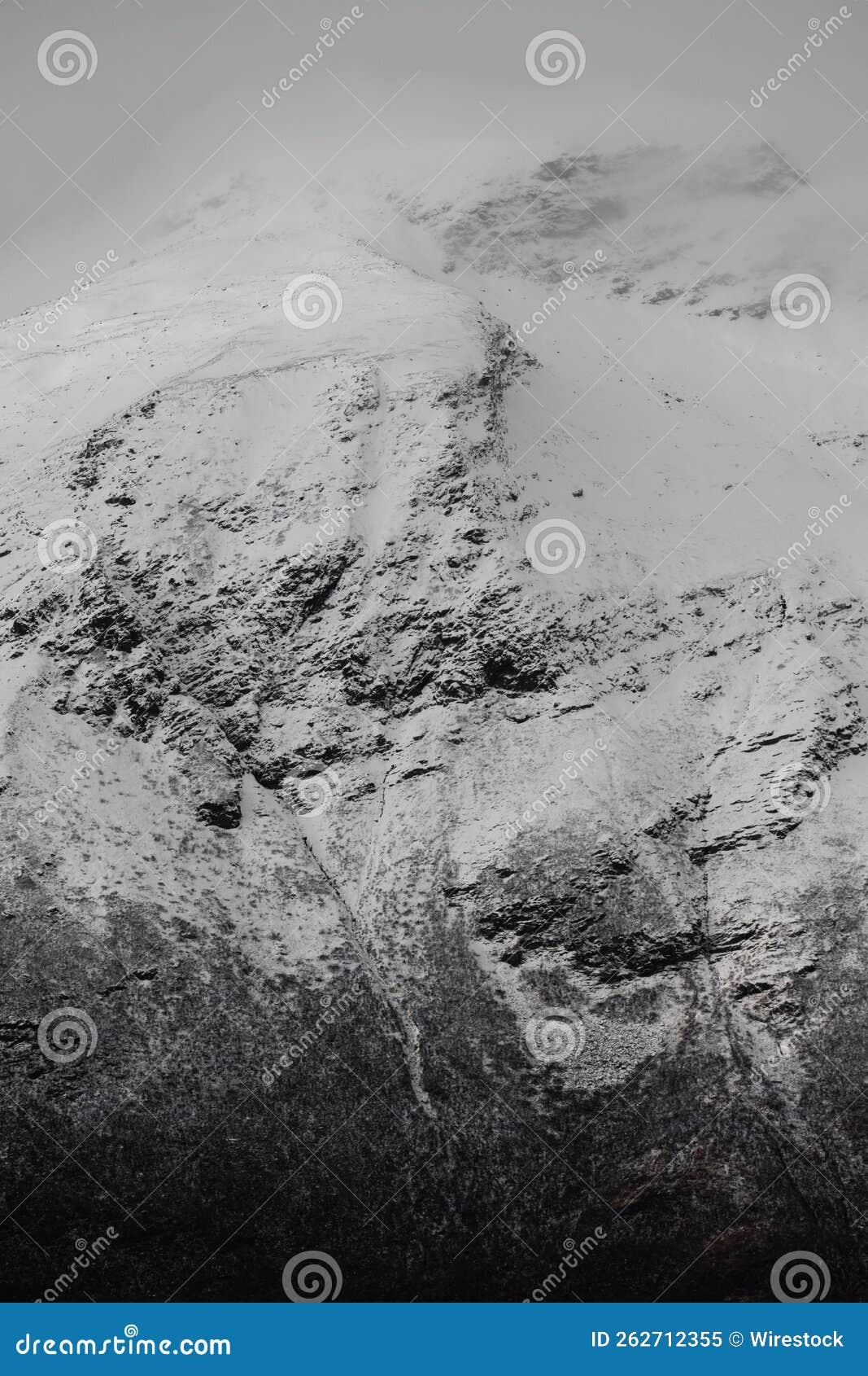 Snowy Rocky Mountain Peak Covered in Clouds Stock Image - Image of ...