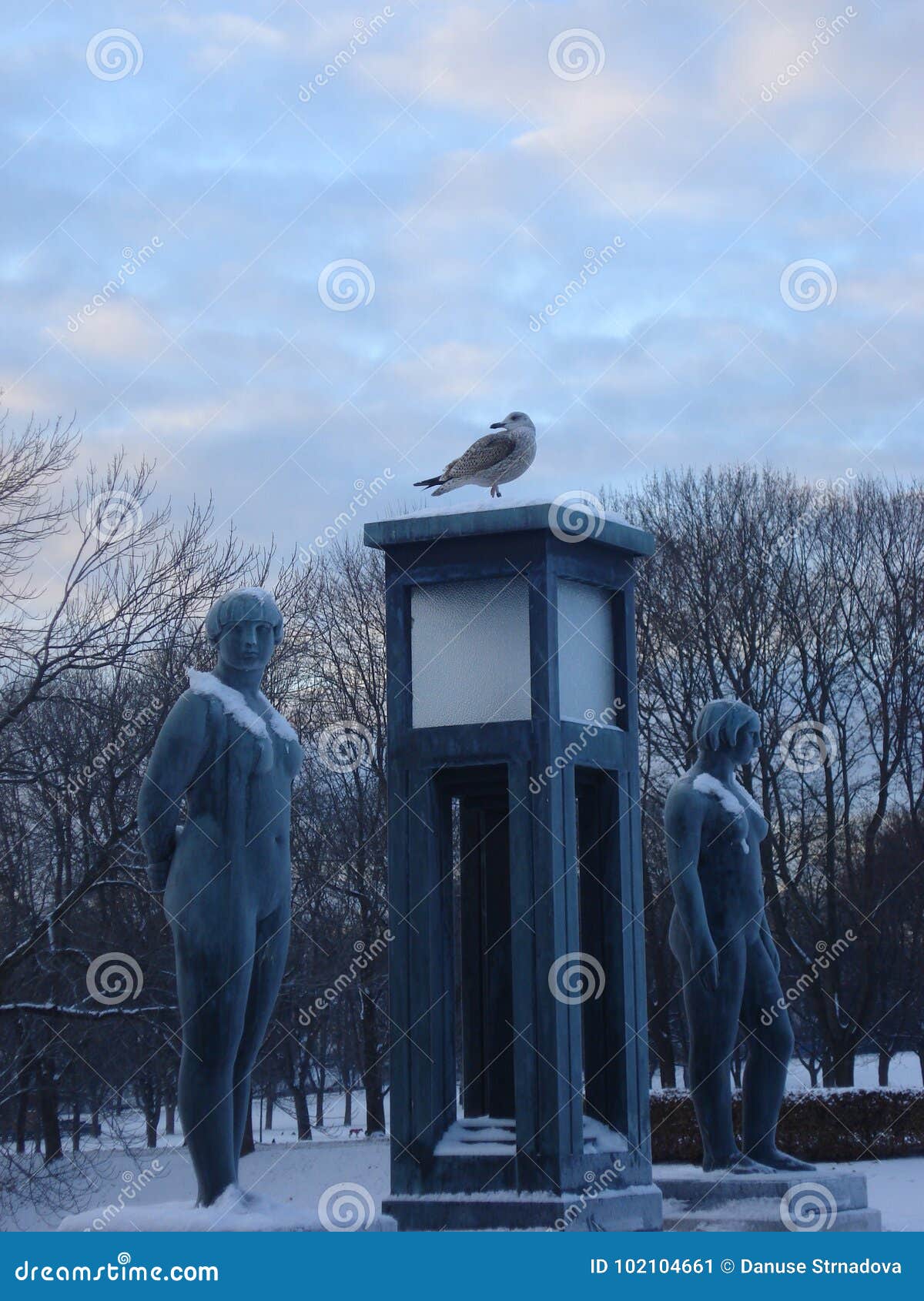 Snowy statues and a bird stock image. Image of winter - 102104661
