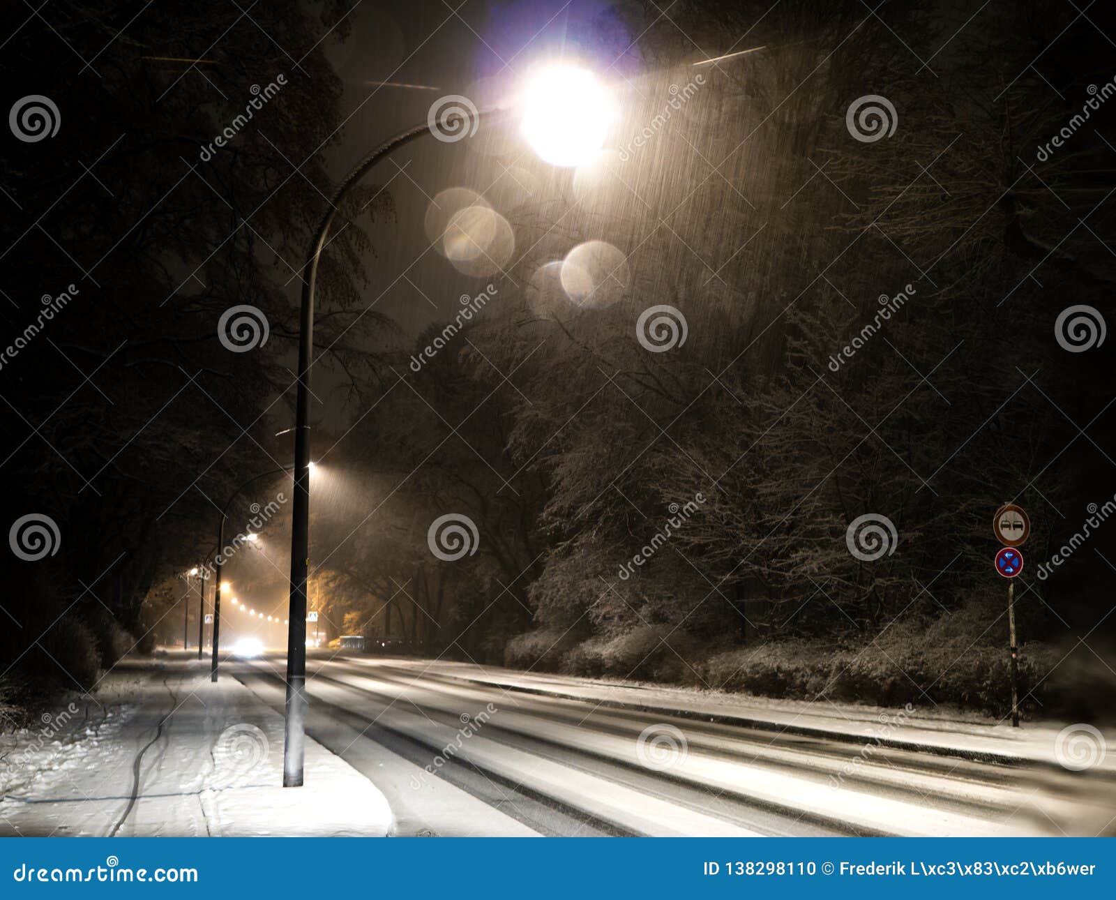 Snowy Street with Street Lights at Night Stock Photo - Image of snow ...