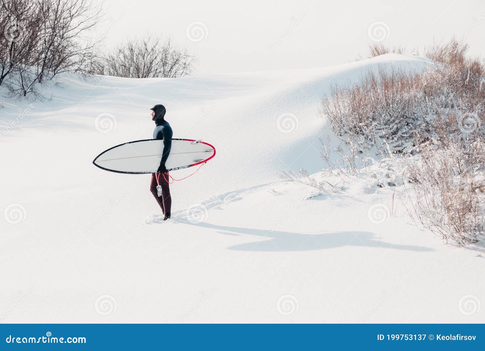 Snowy Winter and Surfer with Surfboard. Winter and Surfer in Wetsuit ...