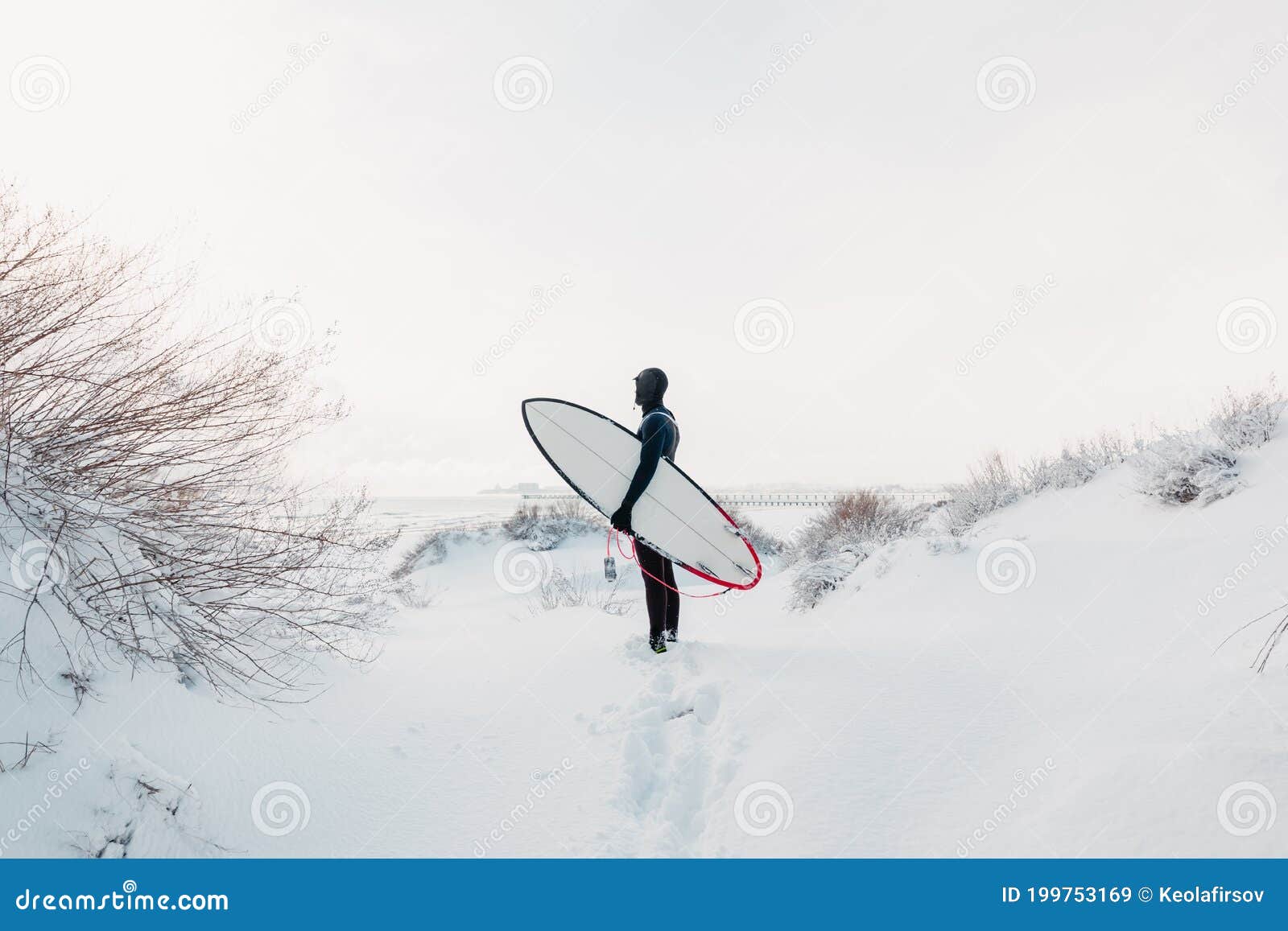Snowy Winter and Surfer with Surfboard. Winter and Surfer in Wetsuit ...