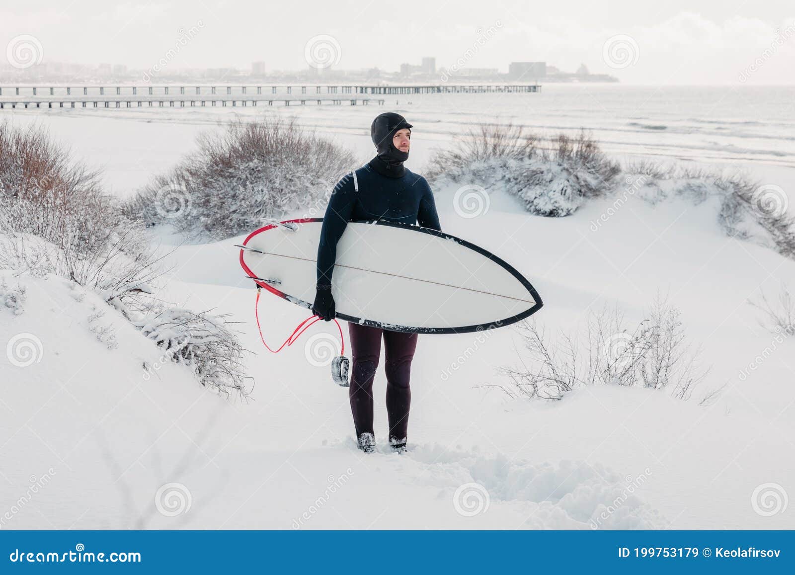 Snowy Winter and Surfer with Surfboard. Winter and Surfer in Wetsuit ...