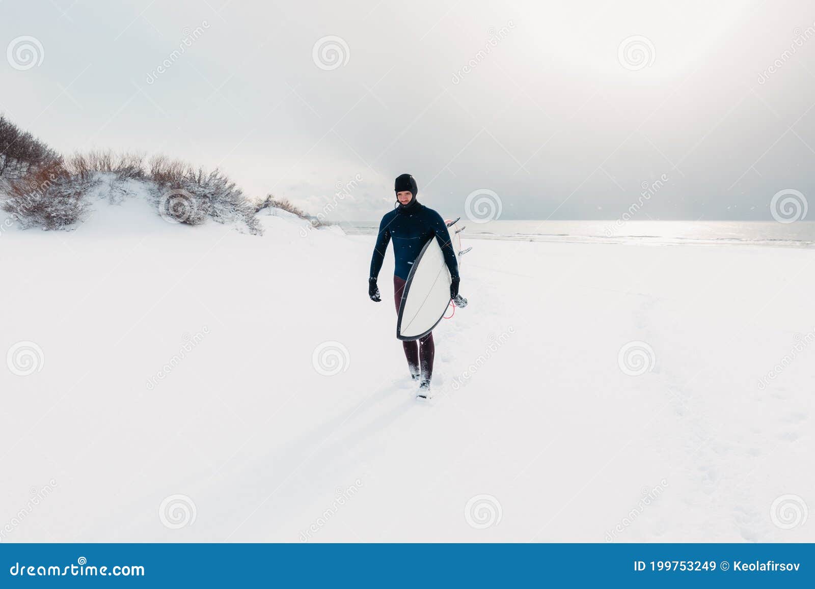Snowy Winter and Surfer with Surfboard. Winter and Surfer in Wetsuit ...