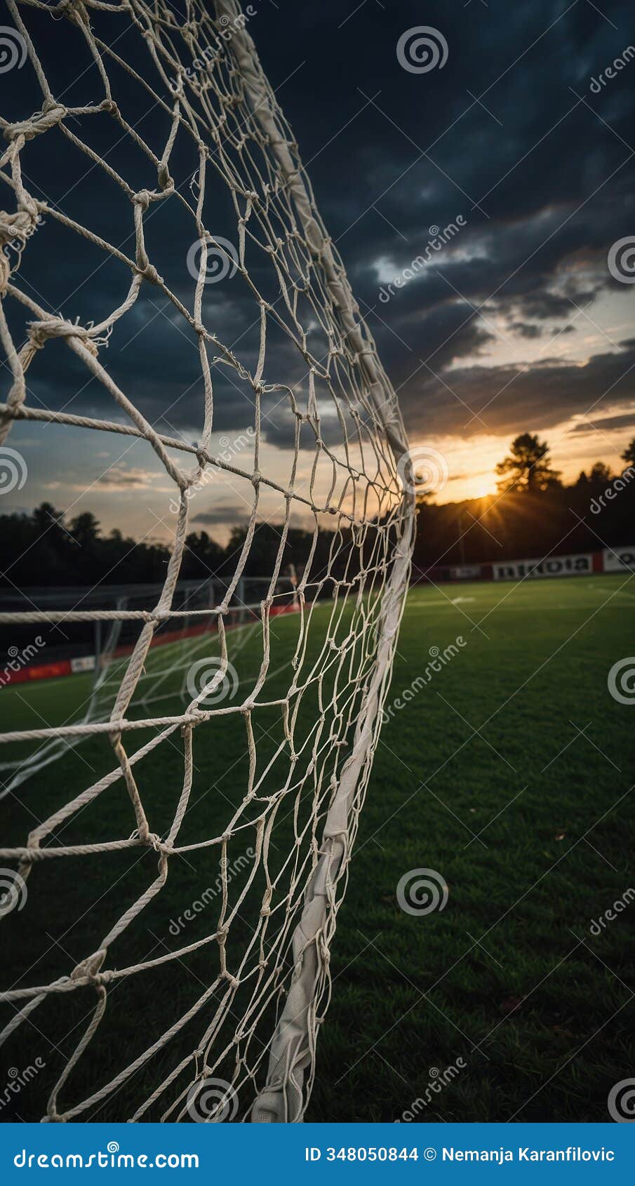 Soccer Ball Breaking through Goal Net at Sunset or Sunrise Stock ...