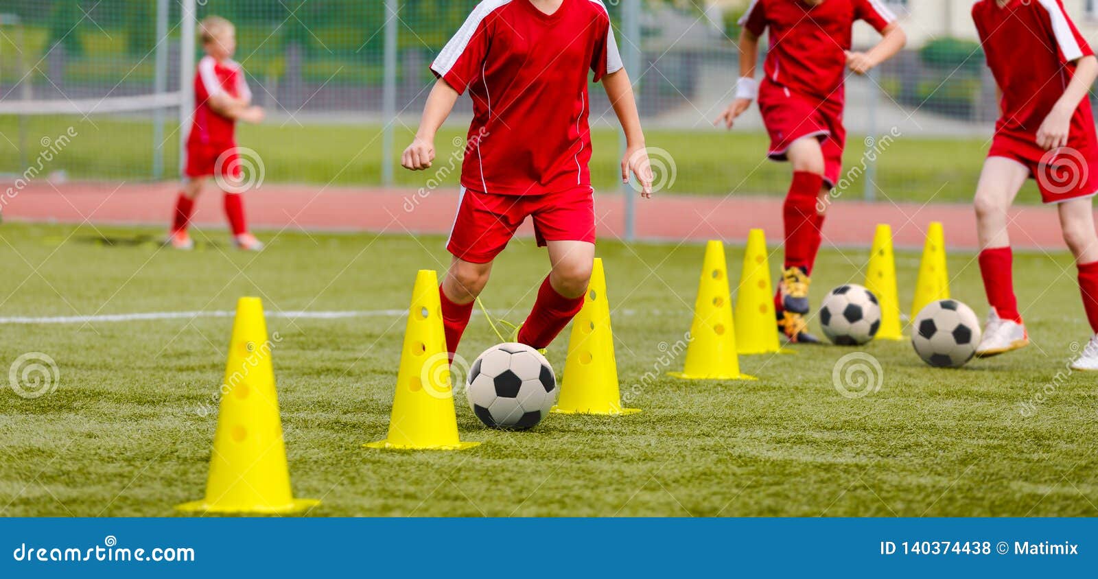 Soccer Camp For Kids. Boys Practice Dribbling In A Field. Players ... Soccer Camp For Kids. Boys Practice Dribbling In A Field. Players ...