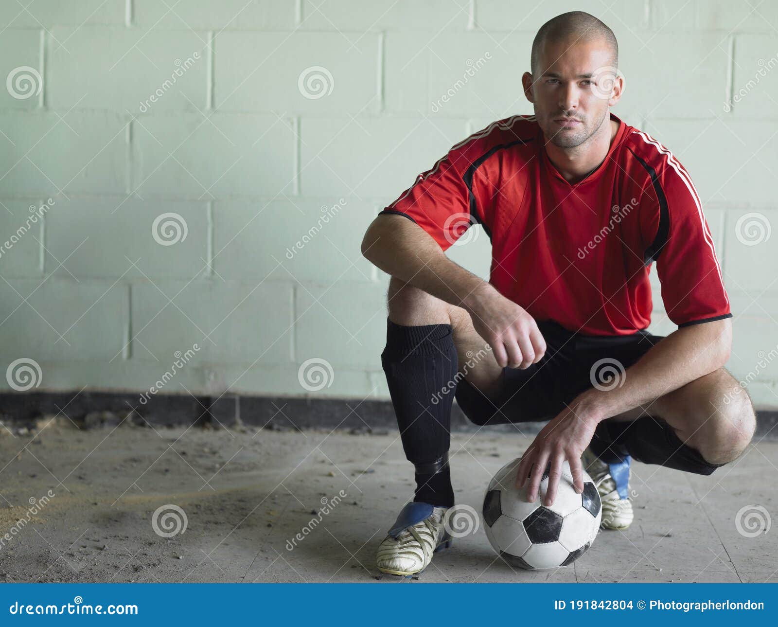 Soccer Player Crouching with Ball Portrait Stock Photo - Image of ...