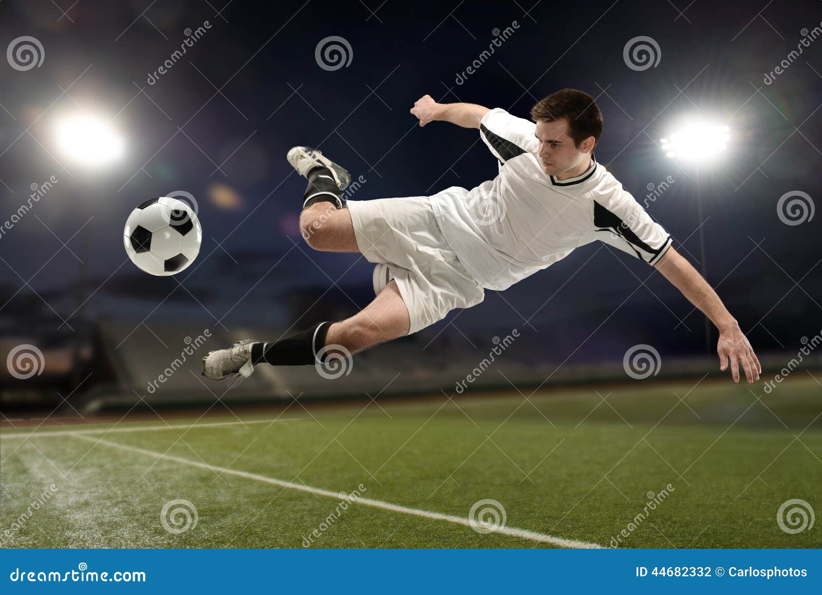 Soccer Player Jumping and Kicking Stock Photo - Image of uniform ...