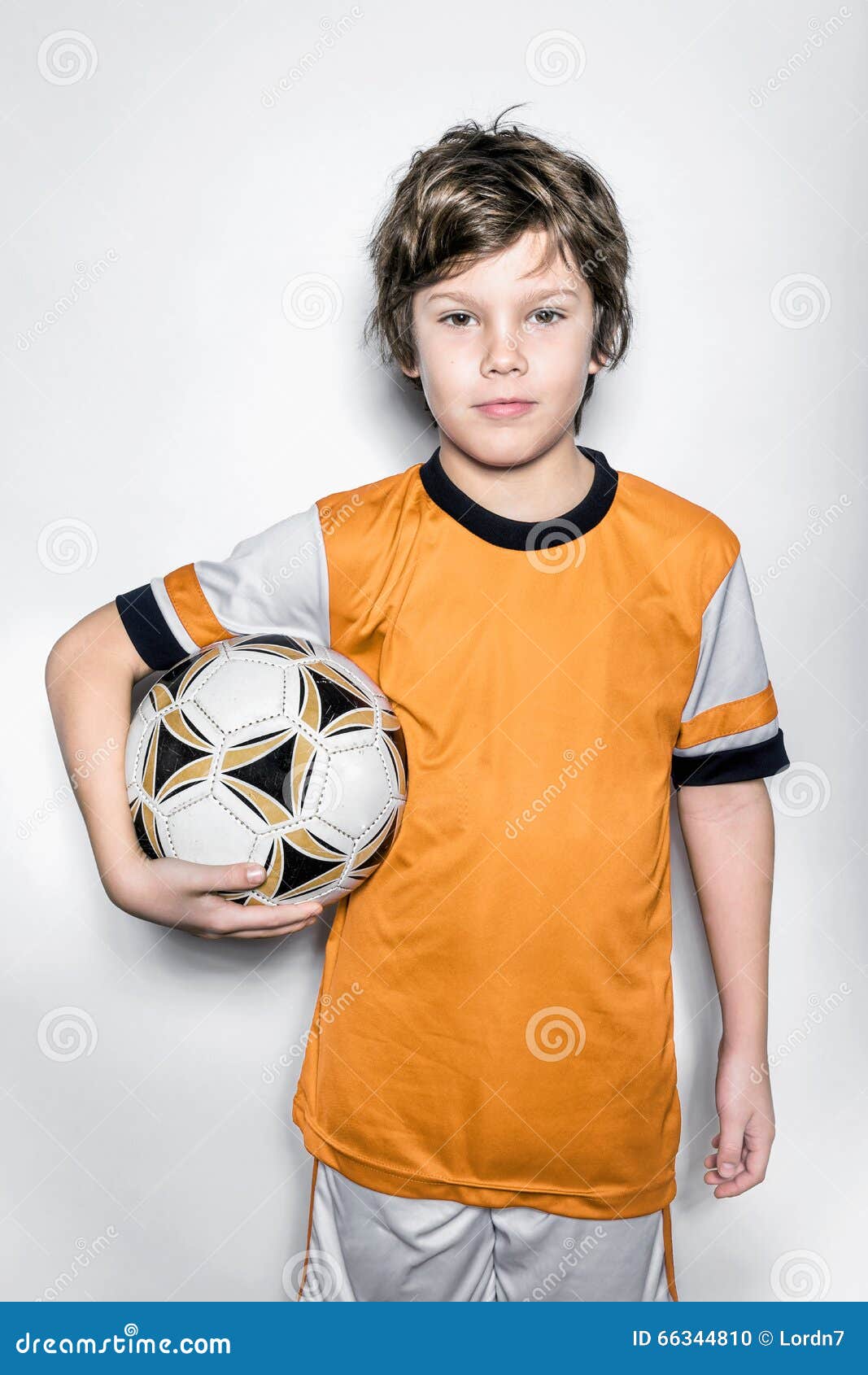 Soccer Player Kid in Orange Uniform with Ball Stock Photo - Image of ...