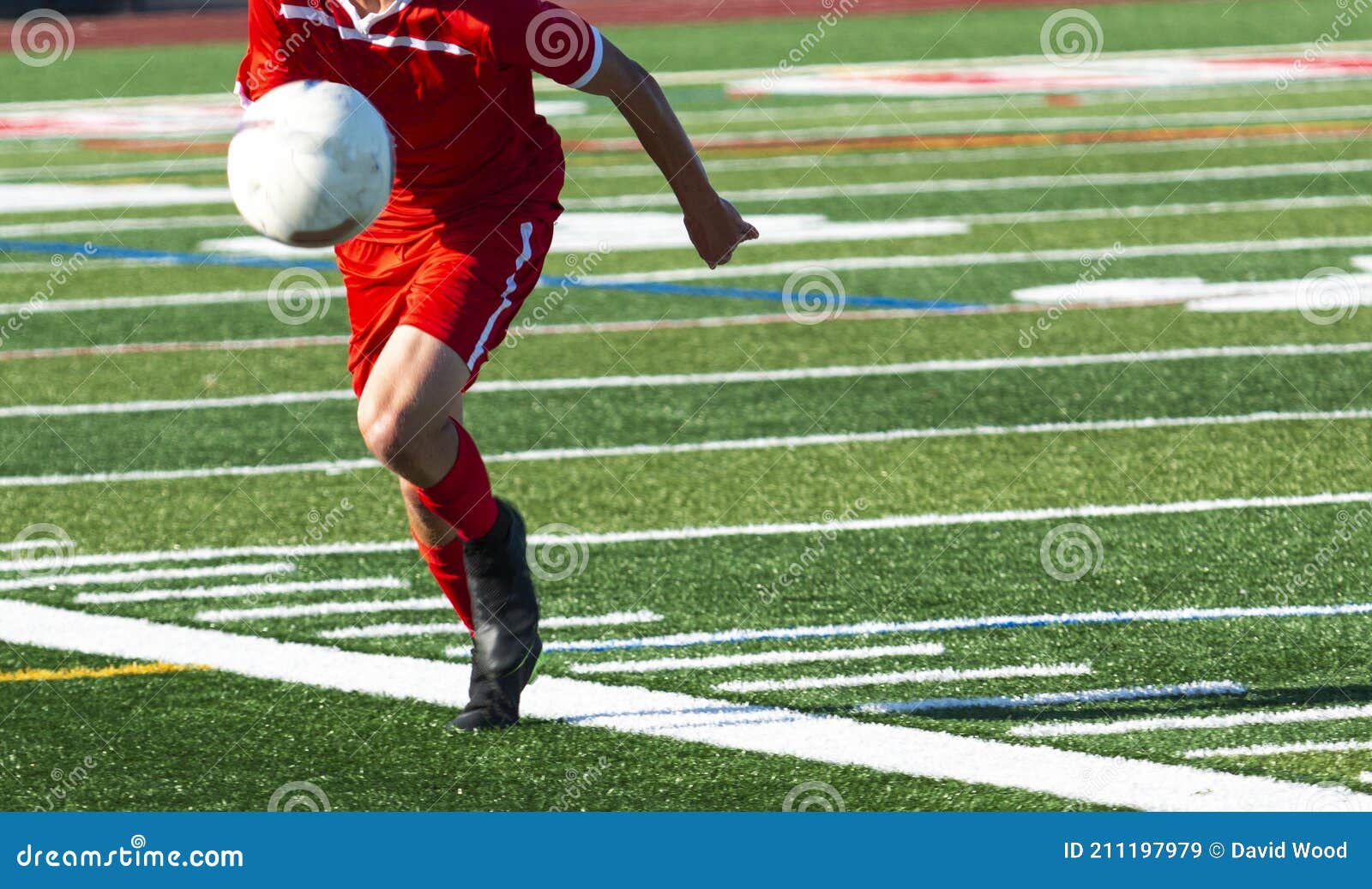 Soccer Player in Red Uniform Chasing the Ball Stock Image - Image of ...