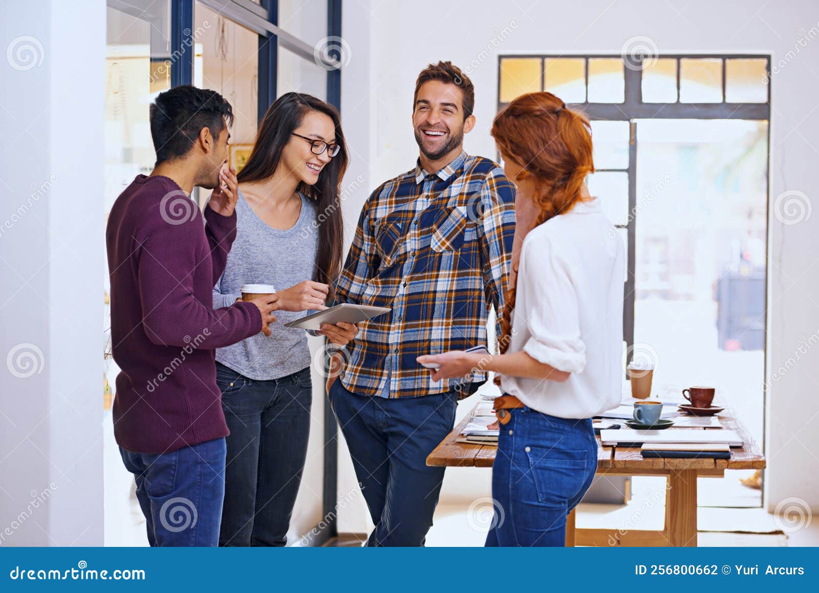 Socializing with the Team. Four Young Designers Having a Discussion in ...