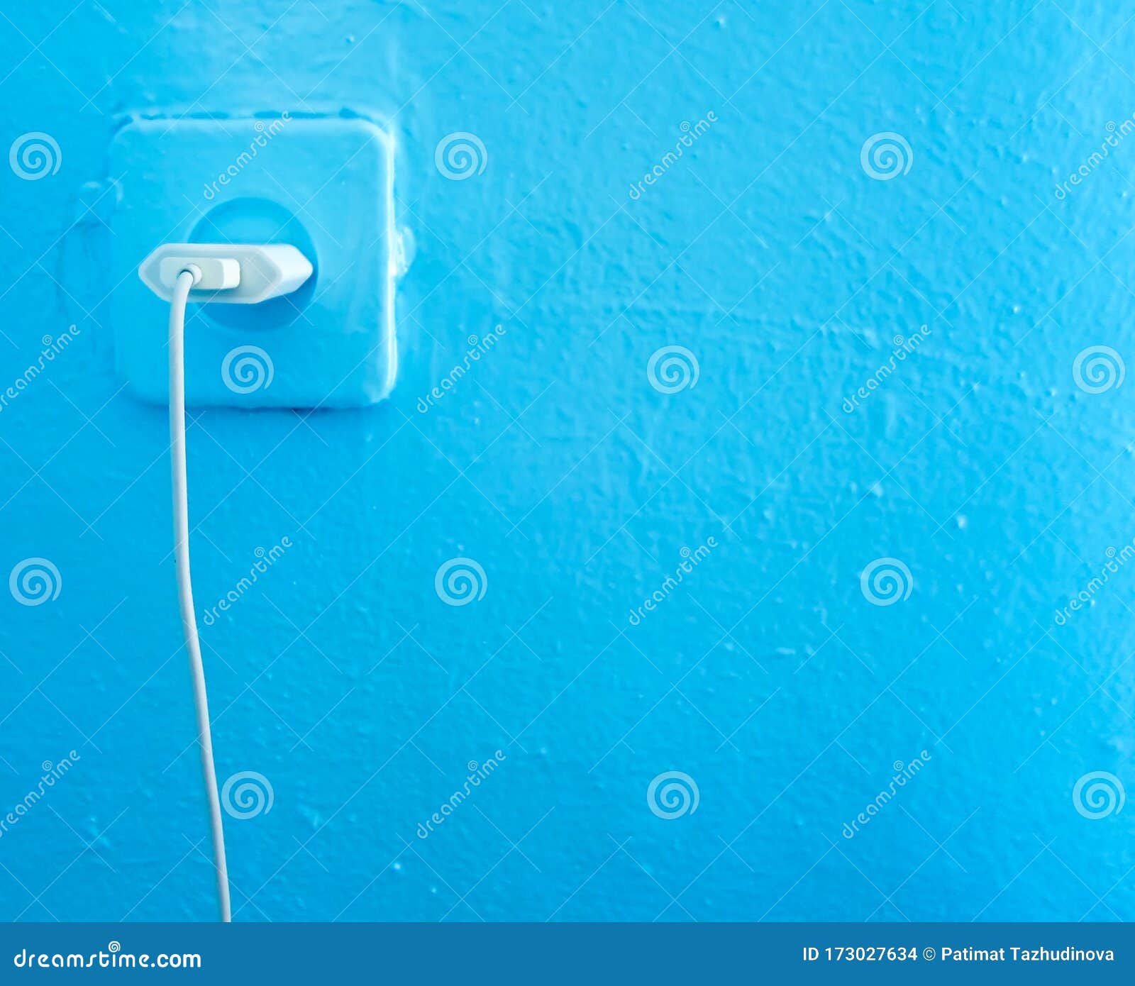 Socket with Plug on a Blue Wall. Electric Plug and Cord Stock Photo ...