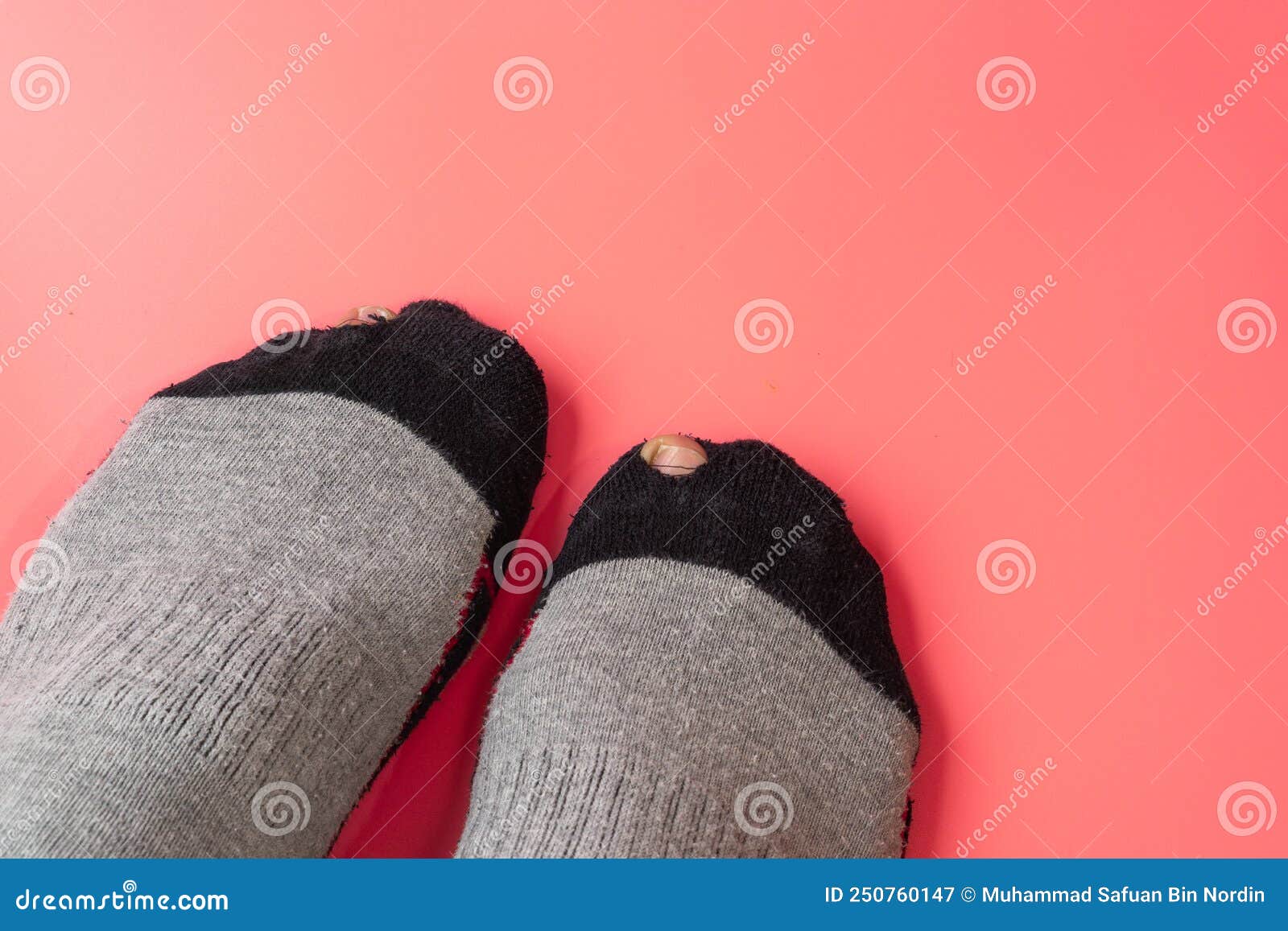 Socks with a Hole on a Light Pink Background.Broken Sock with a Hole ...