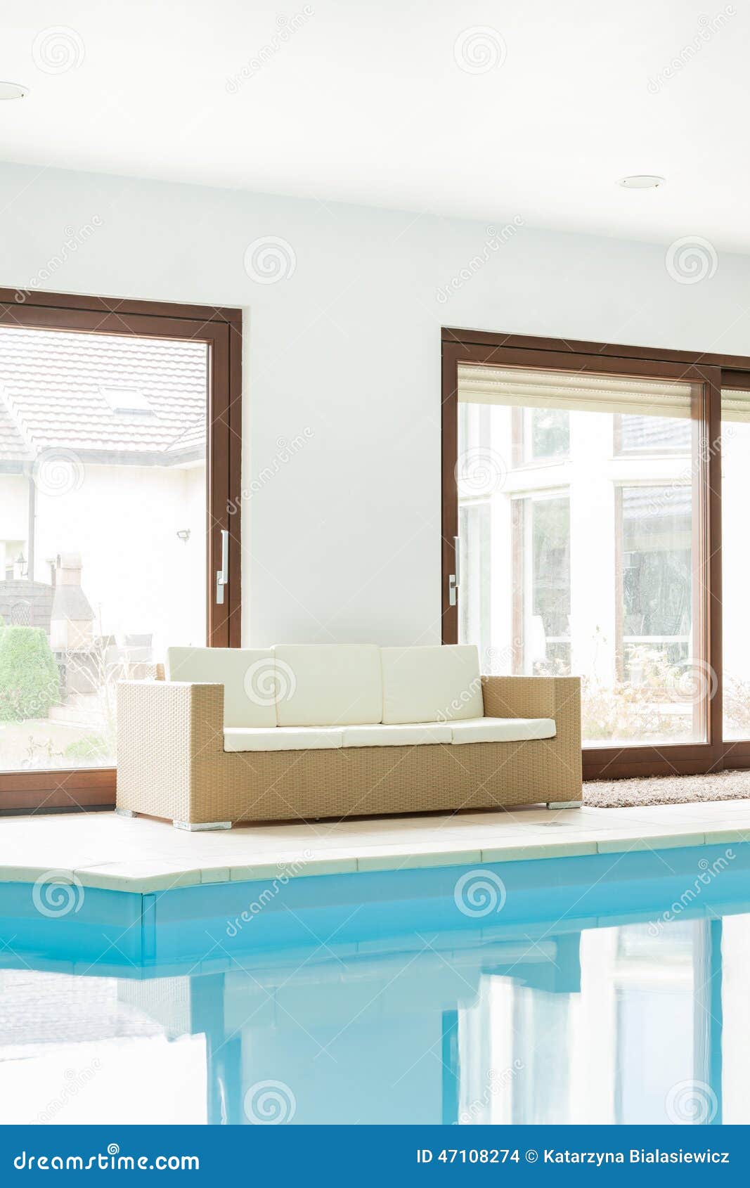 Sofa at the swimming pool stock photo. Image of indoors - 47108274