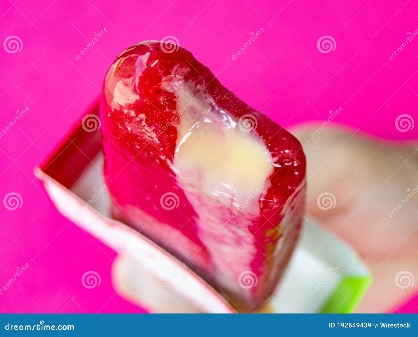 Soft Focus of a Melting Red Ice Pop on a Drip Catcher Against a Pink ...
