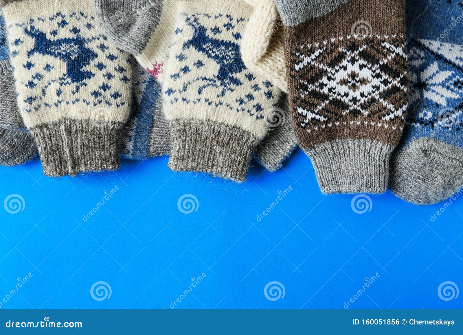 Soft Knitted Socks on Blue Background, Flat Lay. Winter Clothes Stock ...