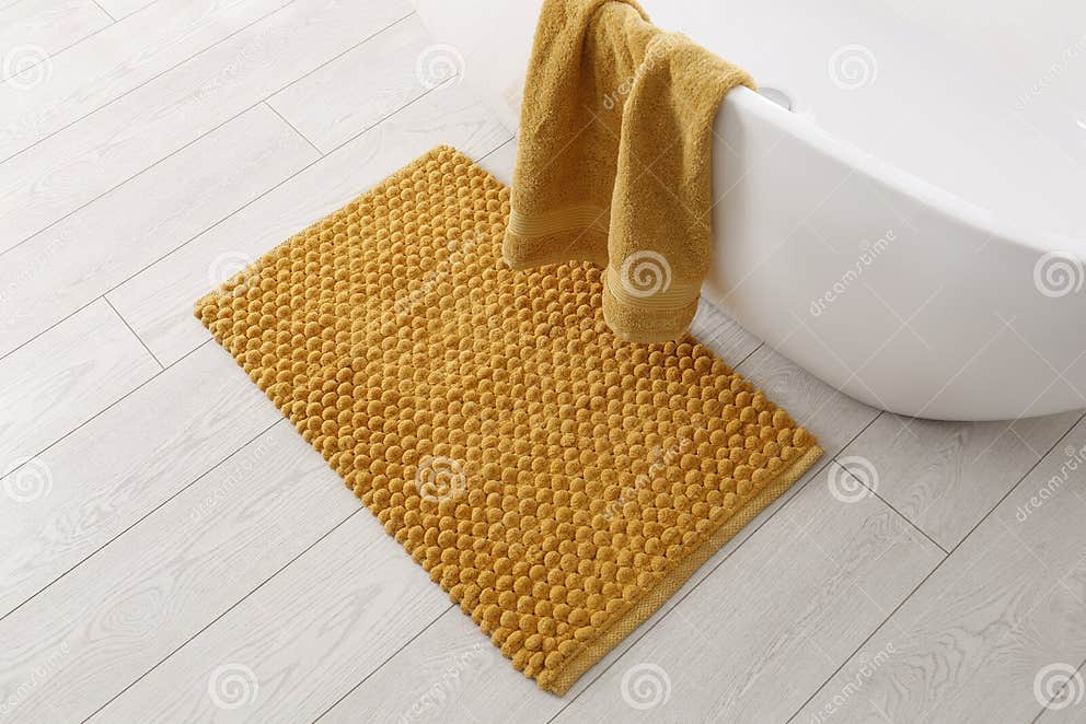 Soft Orange Bath Mat on Floor in Bathroom Stock Image - Image of ...