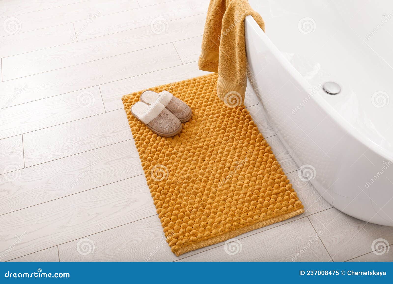 Soft Orange Bath Mat and Slippers on Floor in Bathroom Stock Image ...