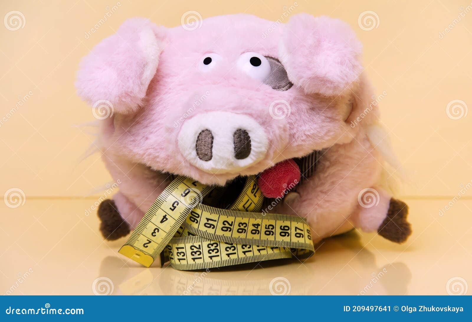 Soft Pig on a Beige Background. the Pig Eats the Meter Stock Image ...