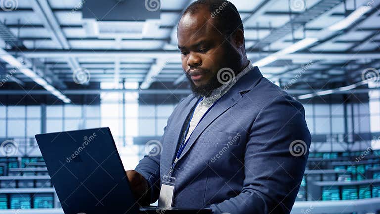 Software Developer In Data Center Runs System Diagnostic Tests On Notebook Stock Image Image
