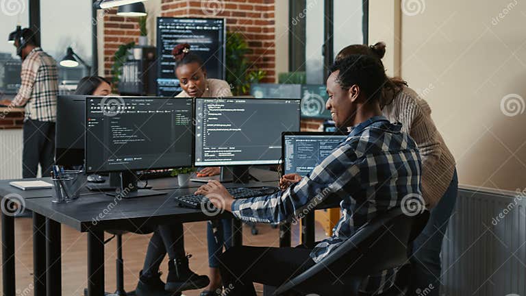 Software Developer Looking at Running Code on Multiple Screens Takes Off Glasses and Doing High ...