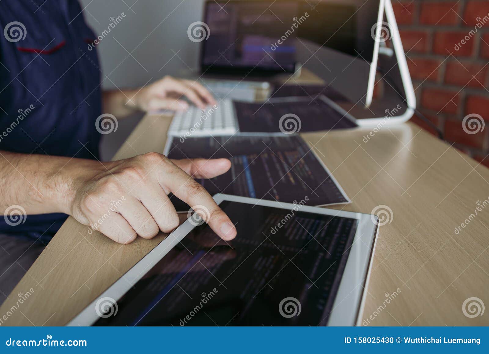 Software Developer Is Pointing To The Paper Working And Analyzing Together The Code Written Into