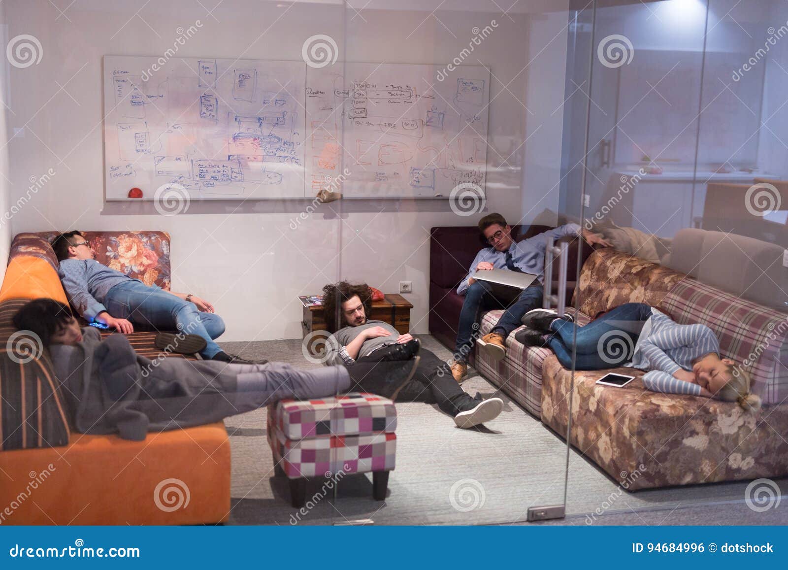 Software Developers Sleeping on Sofa in Creative Startup Office Stock ...