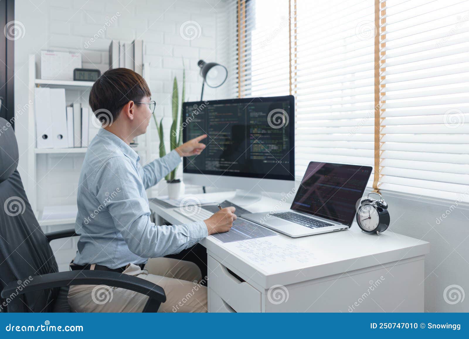 Software Development Concept Male Programmer Checking Data Codes On Document And Computer
