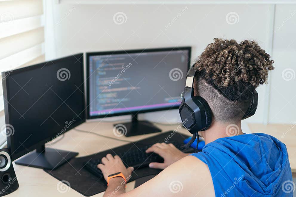 Software Engineer Sitting at Desk and Typing on Computer Keyboard while ...