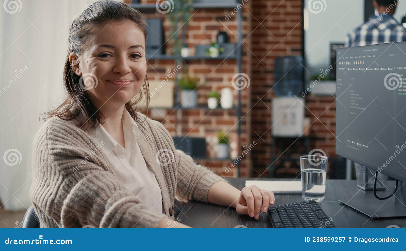Software Engineer Typing Source Code On Computer Keyboard Turning Head And Smiling Stock Image