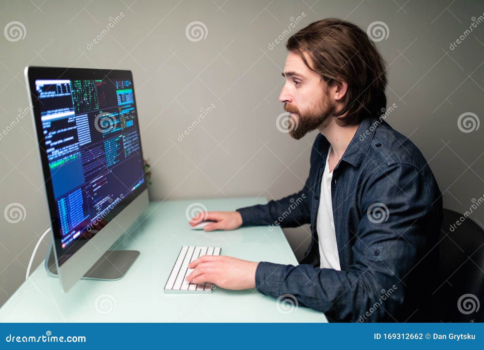 Software Man Developer on the Computer Screen and is Analyzing the Code ...