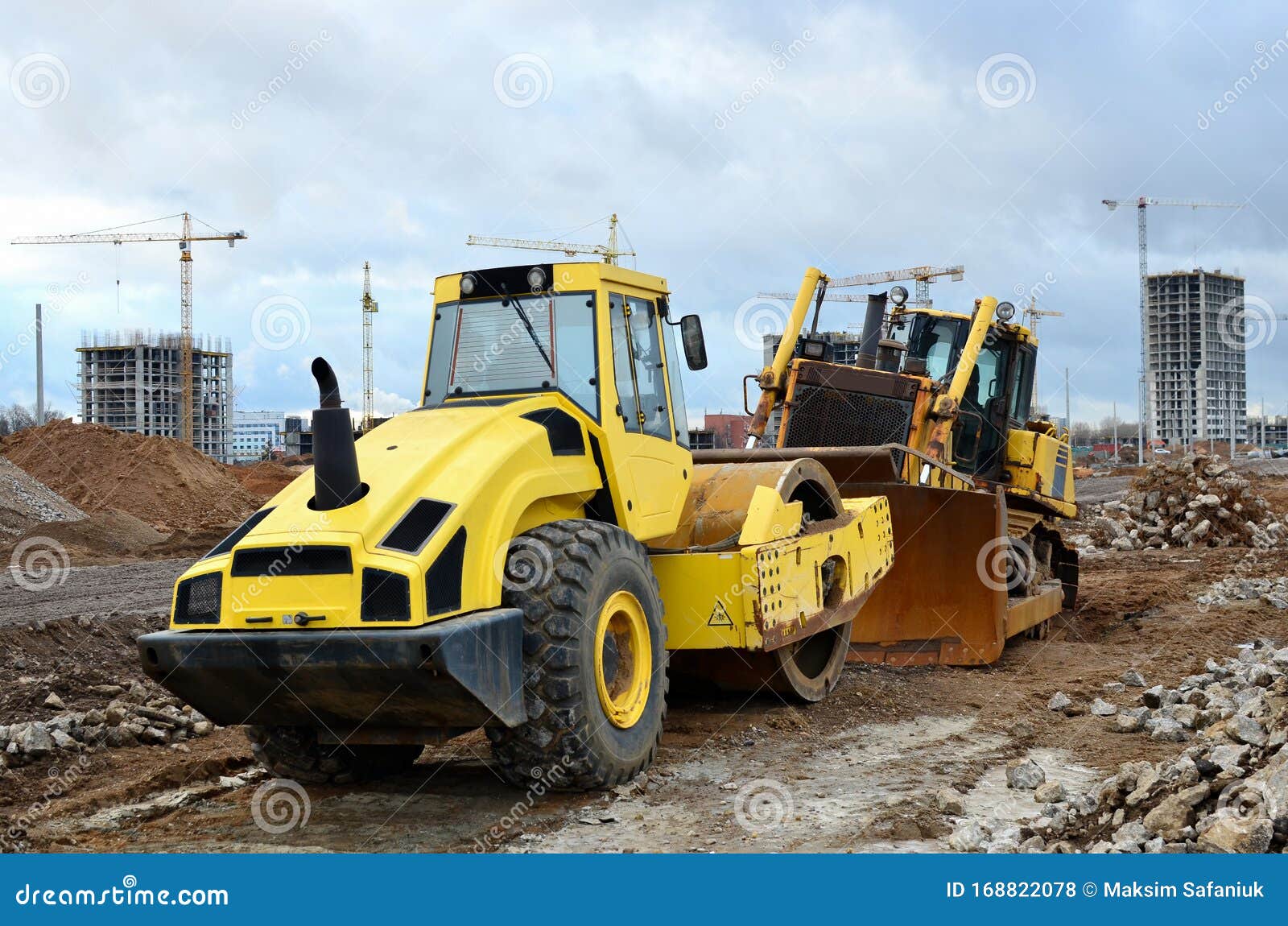 Soil Compactor and Bulldozer at Construction Site Stock Photo - Image ...
