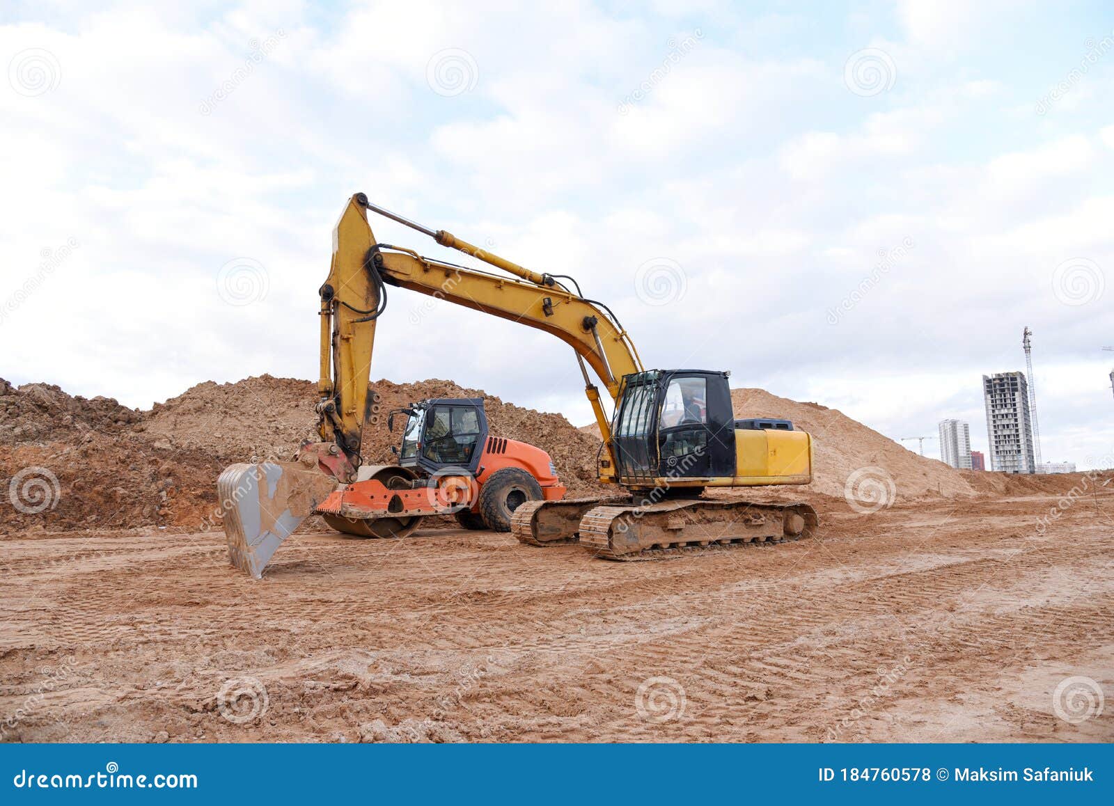 Soil Compactor the Leveling Soil at Construction Site. Excavator and ...