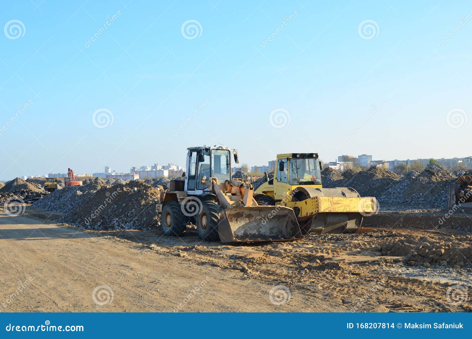 Soil Compactor and Wheel Loader at Construction Site. Vibration Single ...