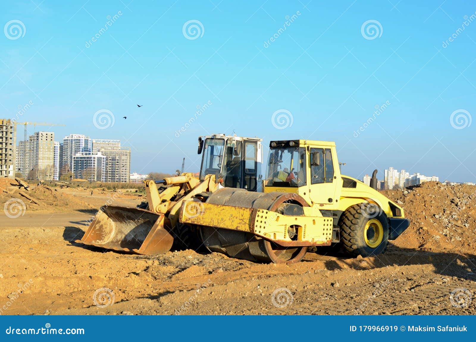Soil Compactor and Wheel Loader at Construction Site. Vibration Single ...