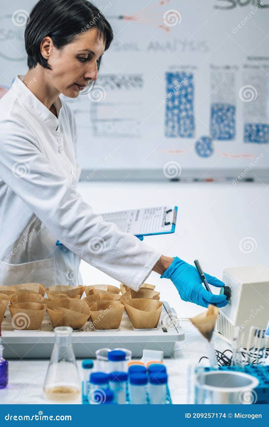 Soil Samples Testing Laboratory. Female Biologist Taking Notes in ...