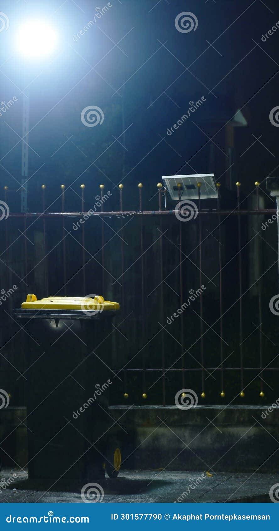 Solar Cell Lamp in Front of Home Spot To Garbage Bin in Night Stock ...