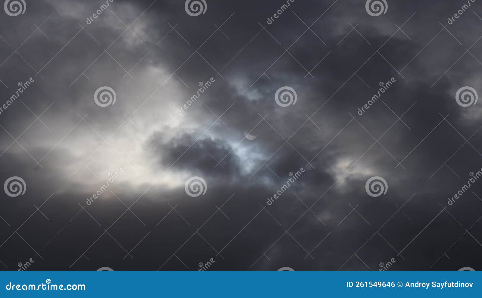 A Solar Eclipse in Cloudy Weather through a Cloud. Partial Solar ...