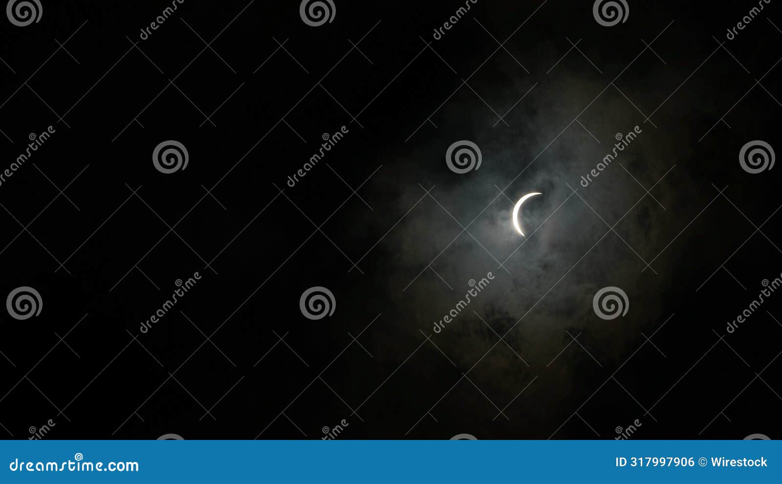 Solar Eclipse with the Moon Shining through Dark Clouds in Waco, Texas ...