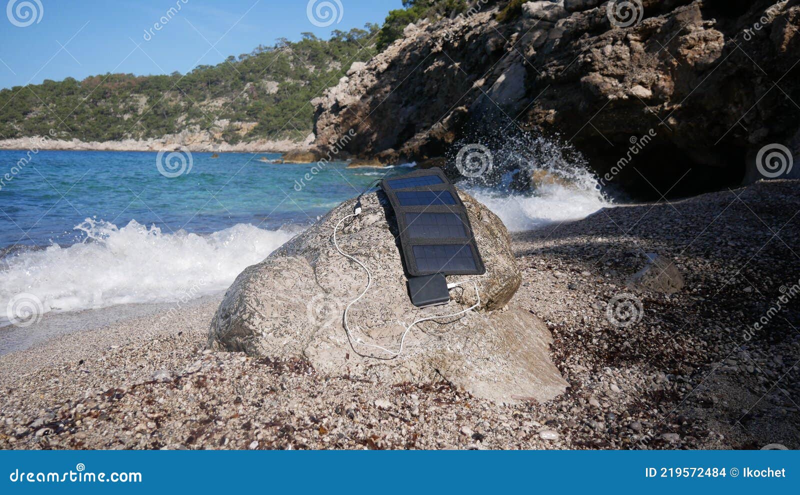 A Solar Panel Charges a Power Bank by the Sea Stock Photo - Image of ...